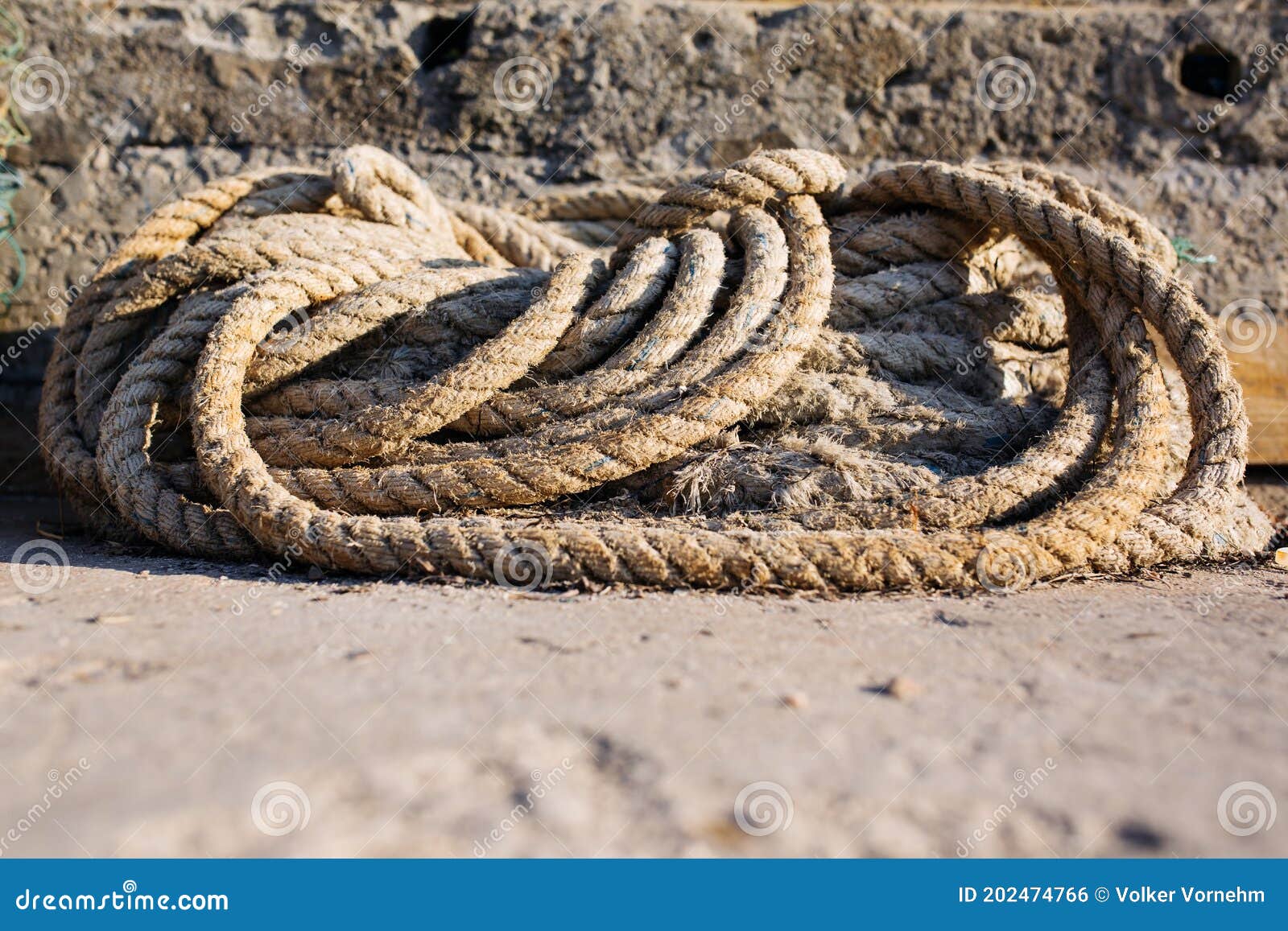 Folded Old Rope Placed on the Concrete Floor at the Pier Stock Photo ...