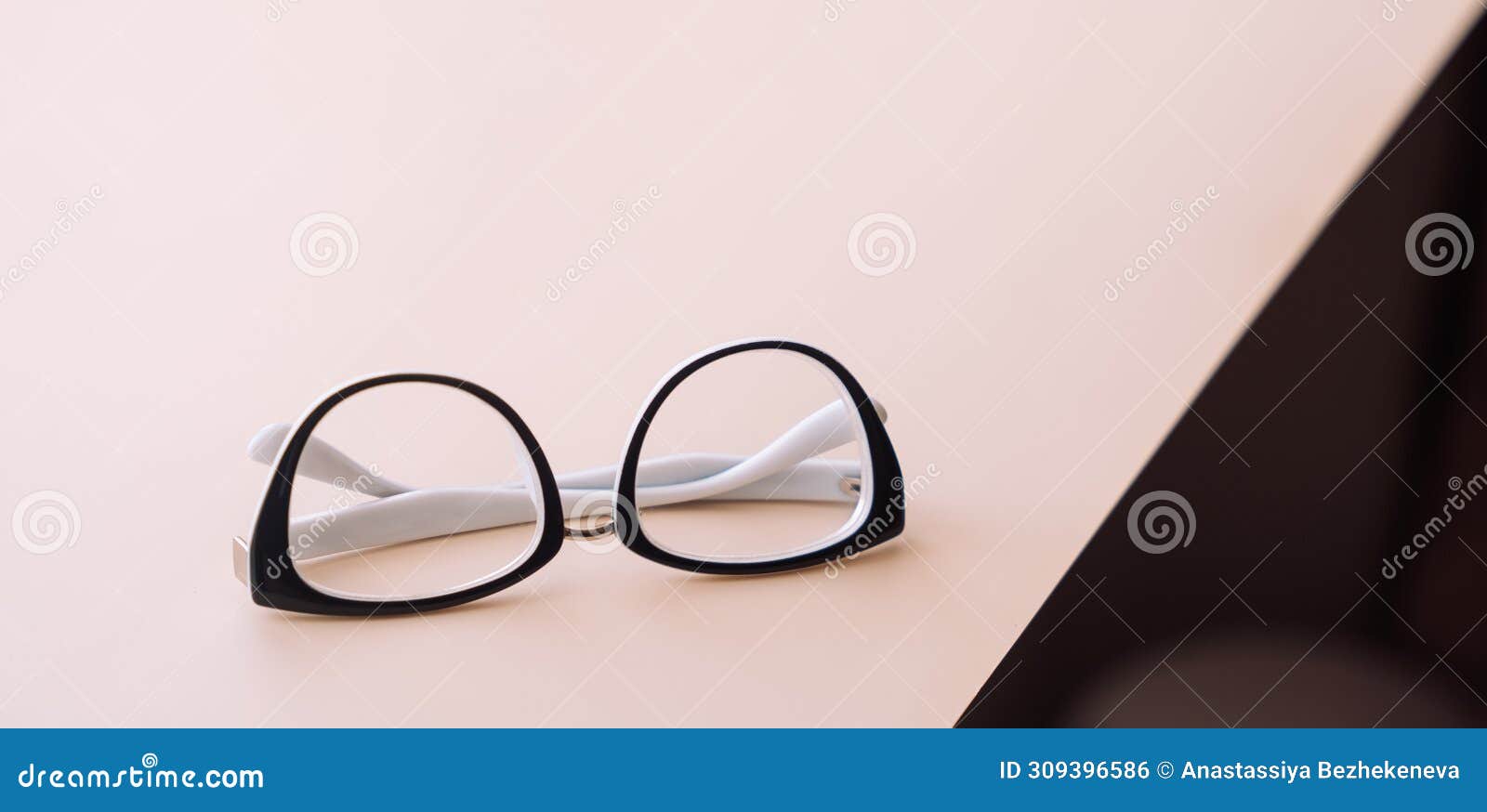 Folded Vision Glasses with Black Frames on a Light Surface Stock Photo ...