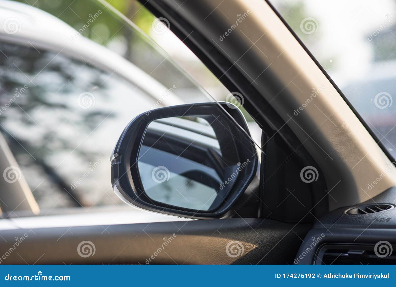 Folded Wing Mirror of a Compact Modern Car, with a Side Window Glass ...