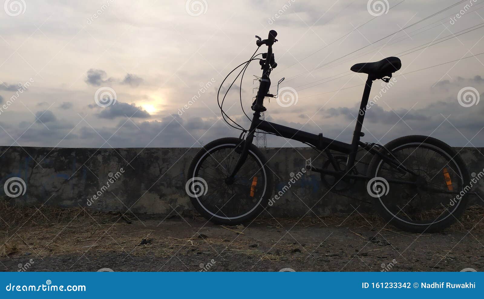 Folding Bike with Sunset Background in a Field Stock Photo - Image of ...
