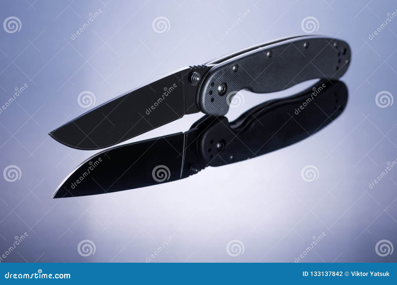 Folding Knife and Its Reflection in the Glass. Knife in the Center of ...