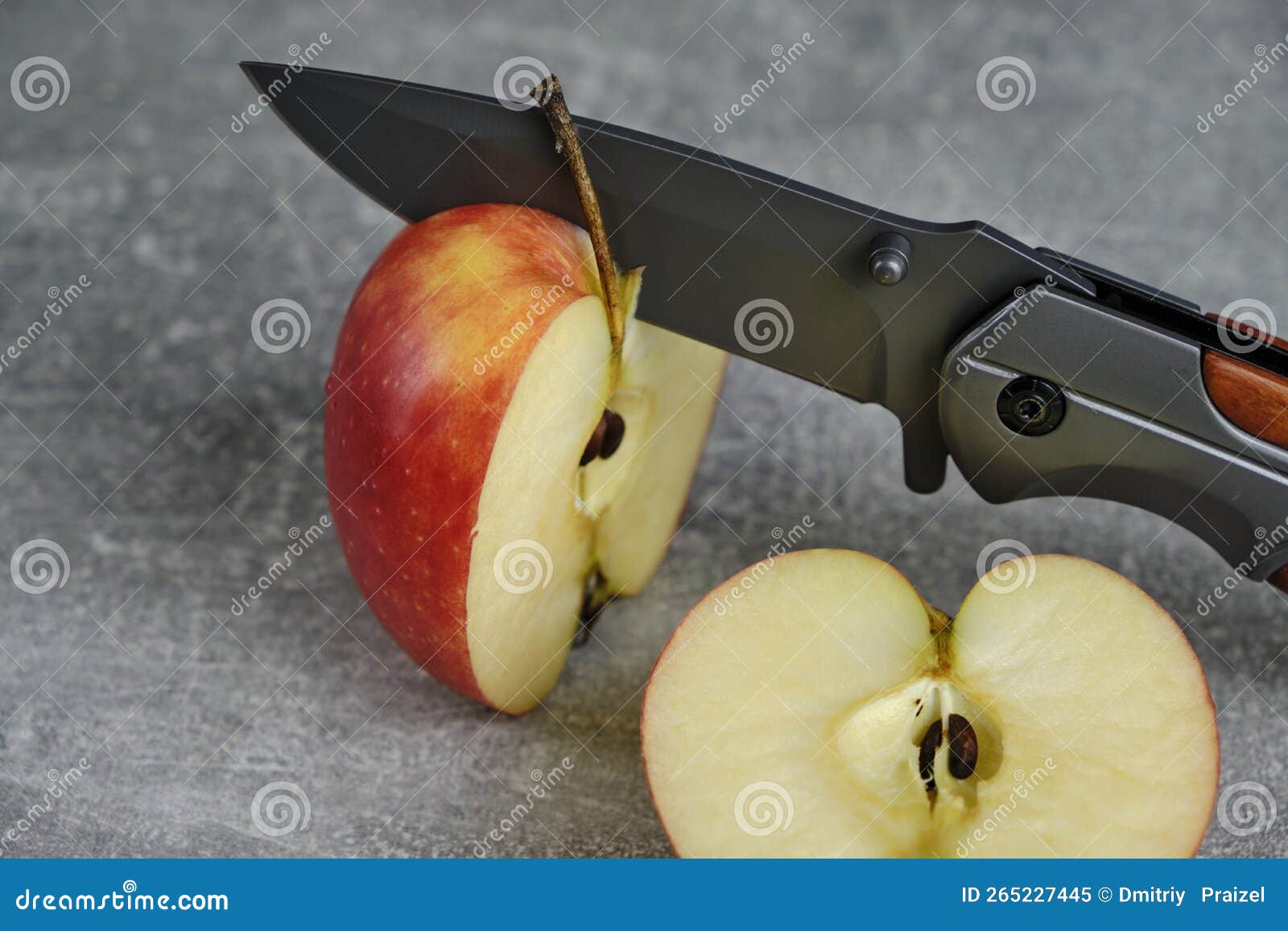 Folding Knife for Survival and Two Halves of Cut Apple. Stock Image ...