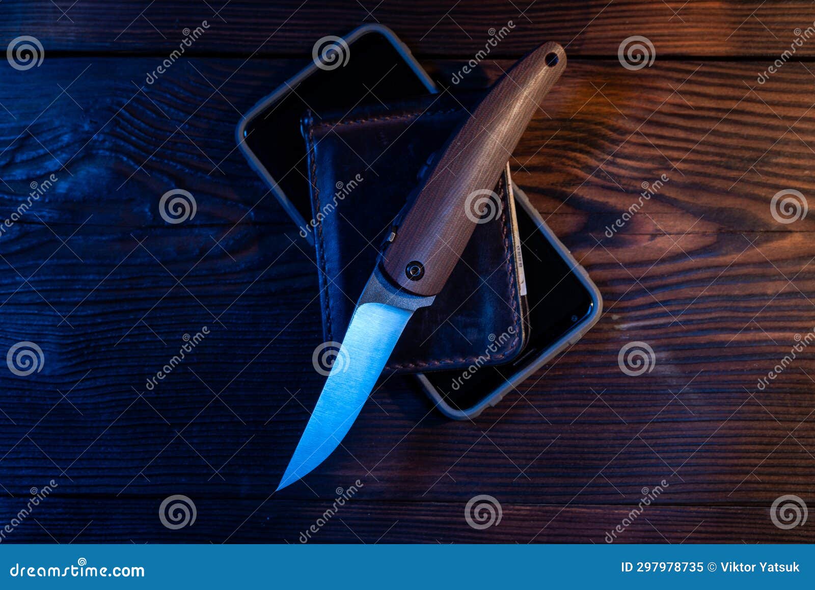 Folding Pocket Knife and Wallet on the Table. a Sharp Knife with a ...