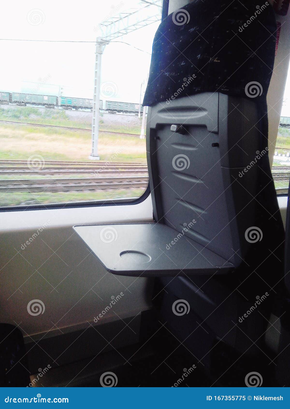 A Folding Table Mounted in the Back of the Chair of a Railway Carriage ...