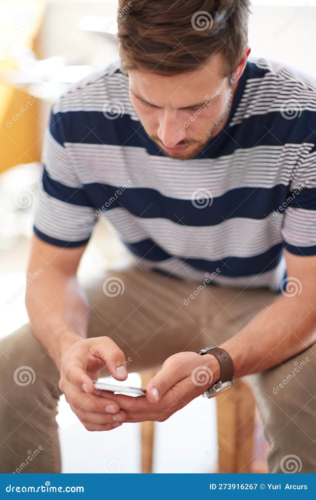 Following Up on His Social Interactions. a Young Man Using His Phone ...