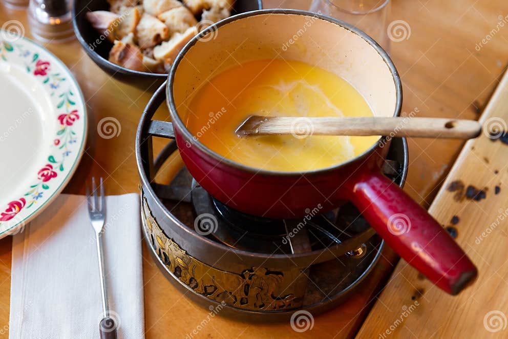 Fondue Savoyarde Heating in Caquelon on Table Stock Photo - Image of ...