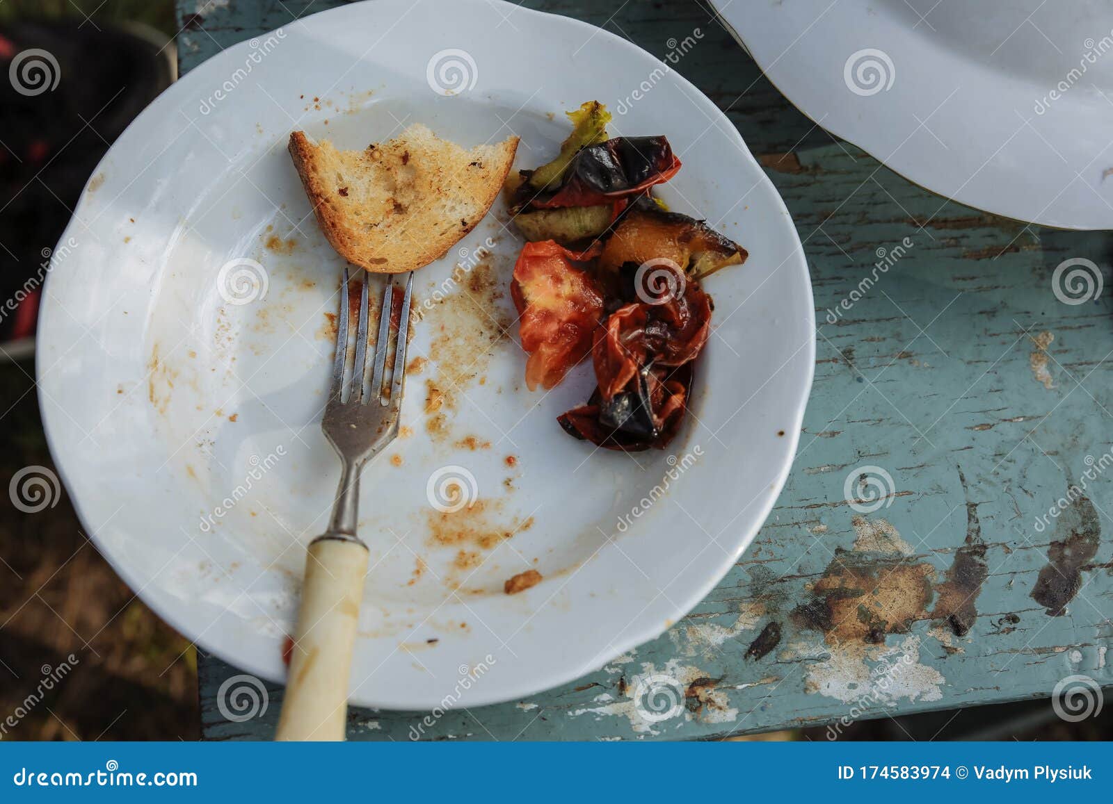 Food Leftovers on the Plate. Vegetables, Meat and Bread Stock Photo ...