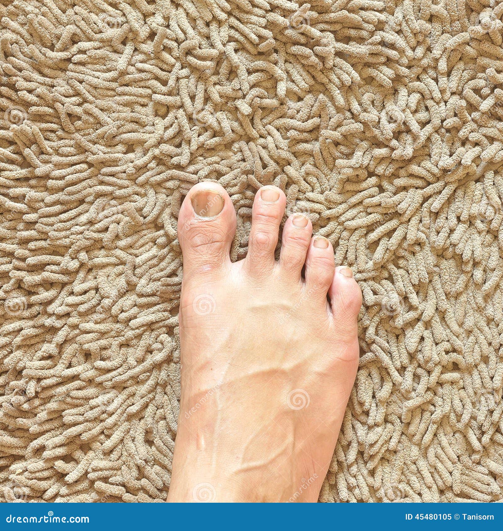 Foot on beige carpet stock image. Image of body, material - 45480105