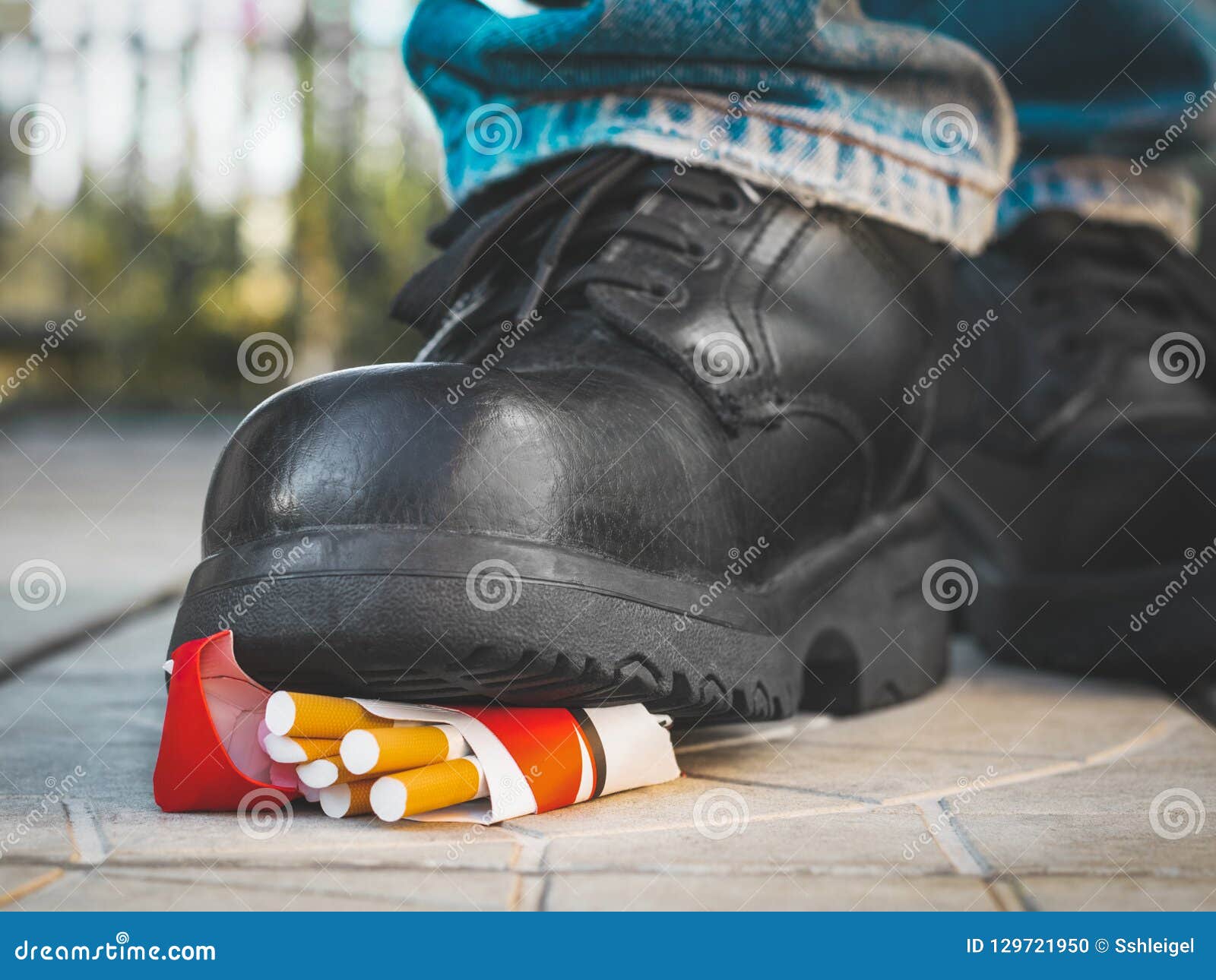 Foot in a Black Boot Crushes a Pack of Cigarettes Stock Photo - Image ...
