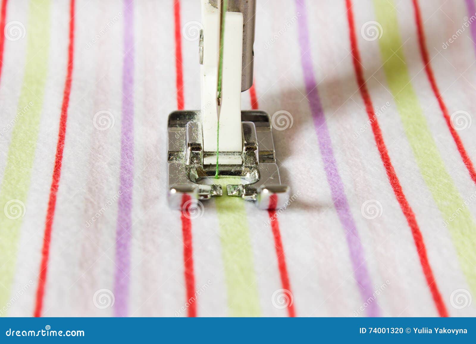 Foot of the Sewing Machine Close-up on a Striped Cloth. Stock Photo ...