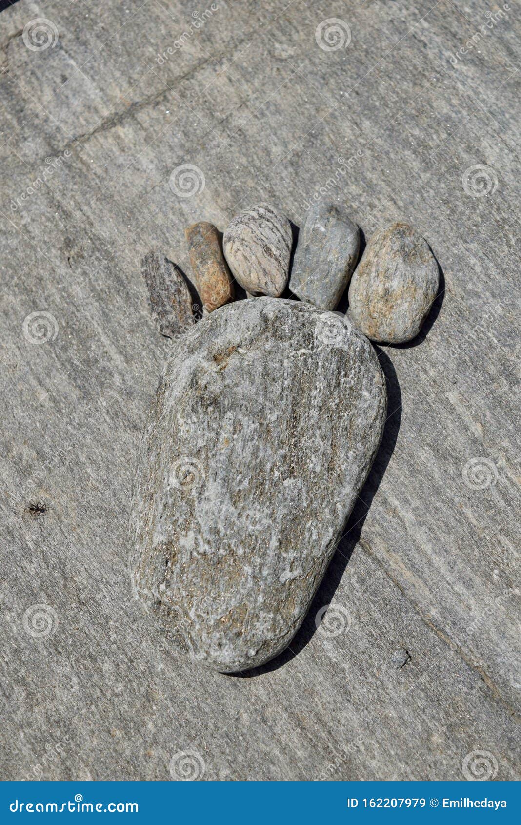 A Foot Shape with Toes Made Out of Rock Pebbles Sitting on a Boulder ...