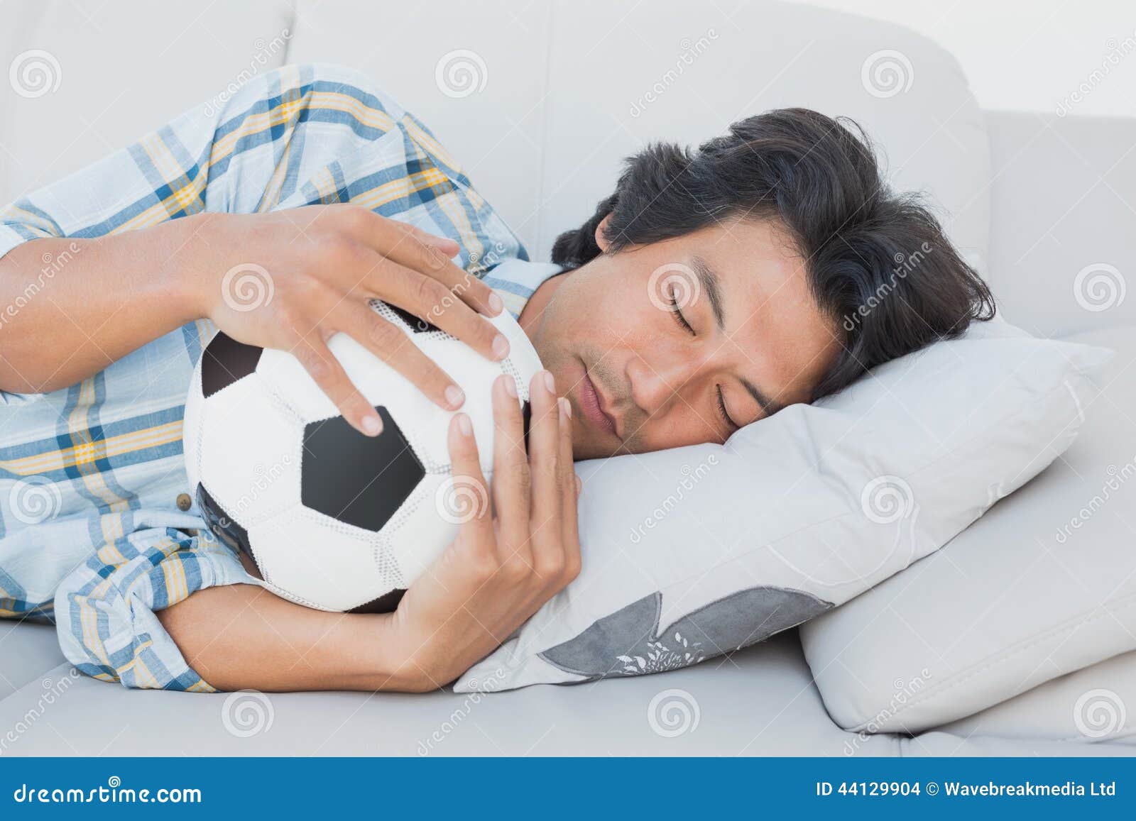 Football Fan Hugging Ball on Couch Stock Photo - Image of cuddling ...