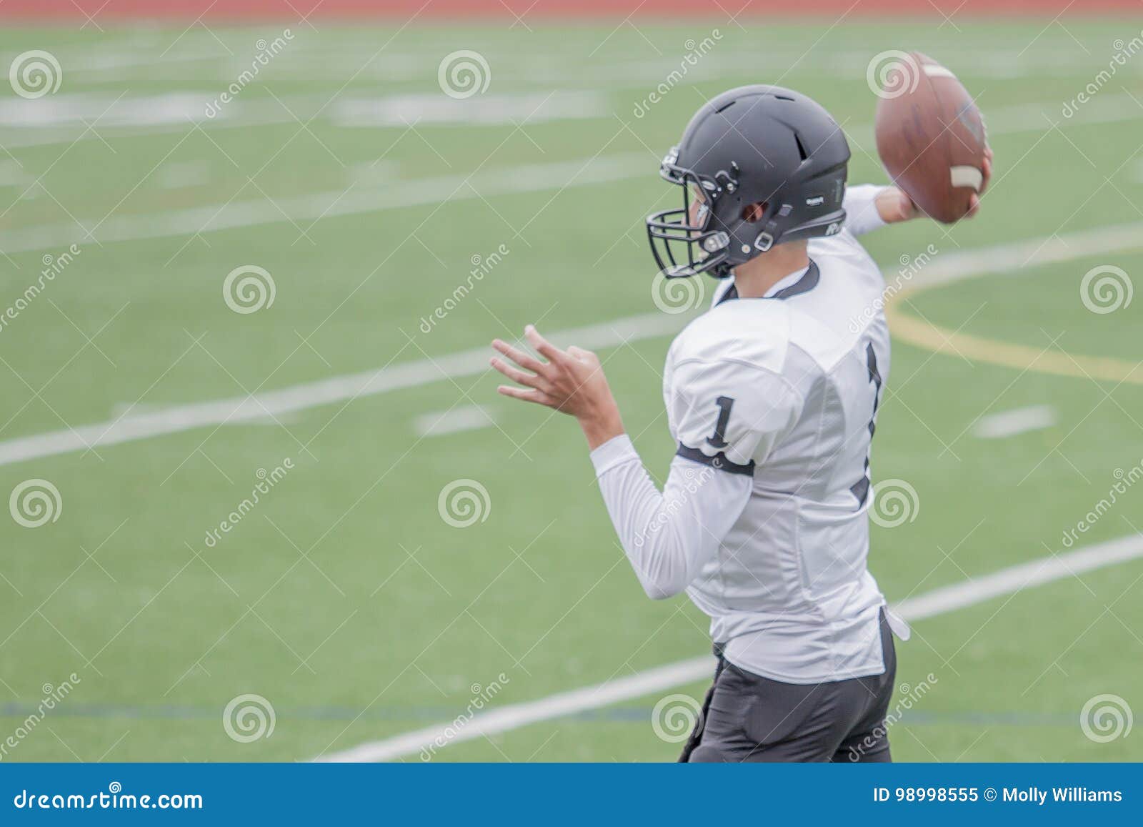 Football Player Throwing Ball Stock Image - Image of stadium, helmet ...
