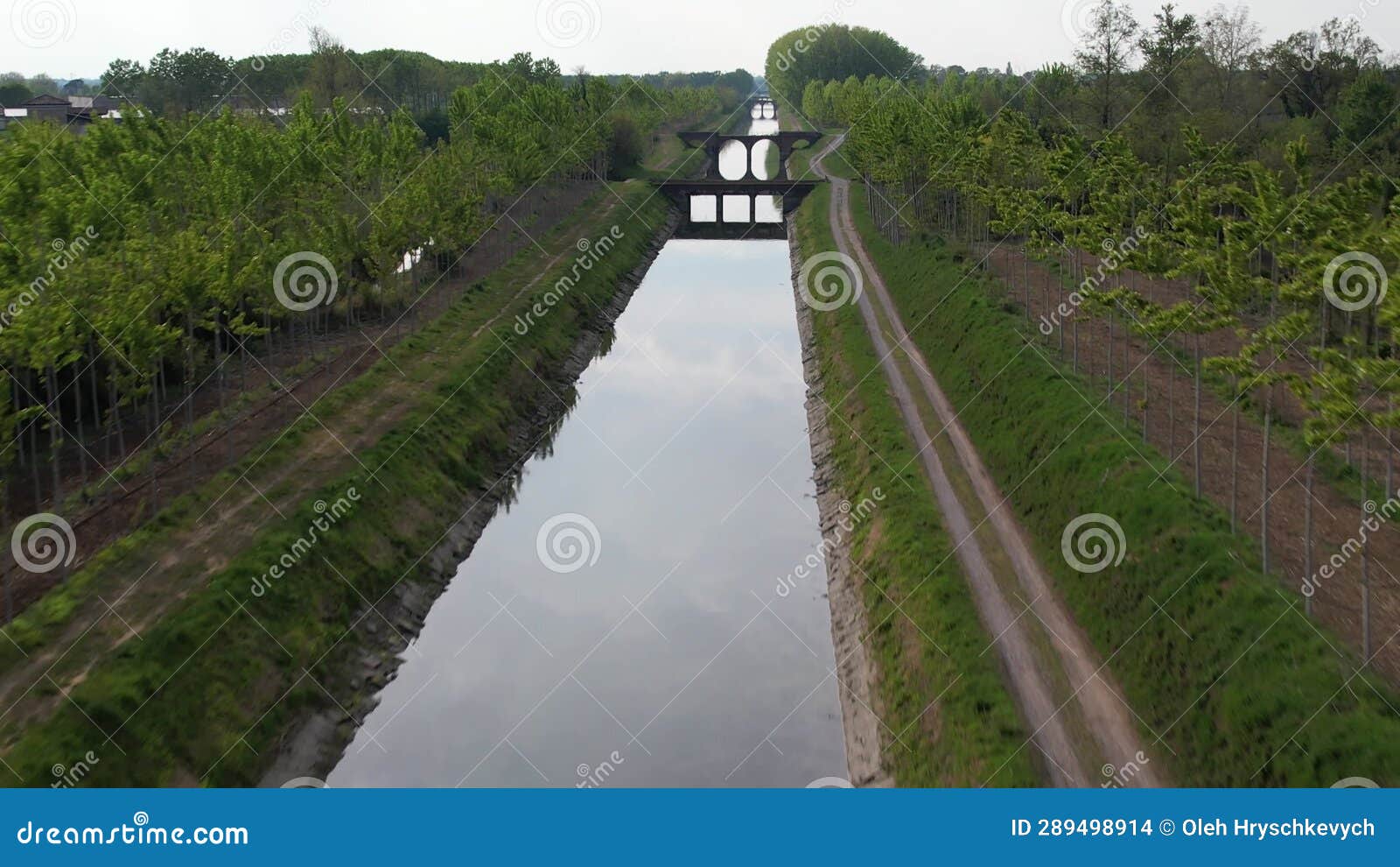 Footbridge Across the River between Fields and Tree Planting in the ...