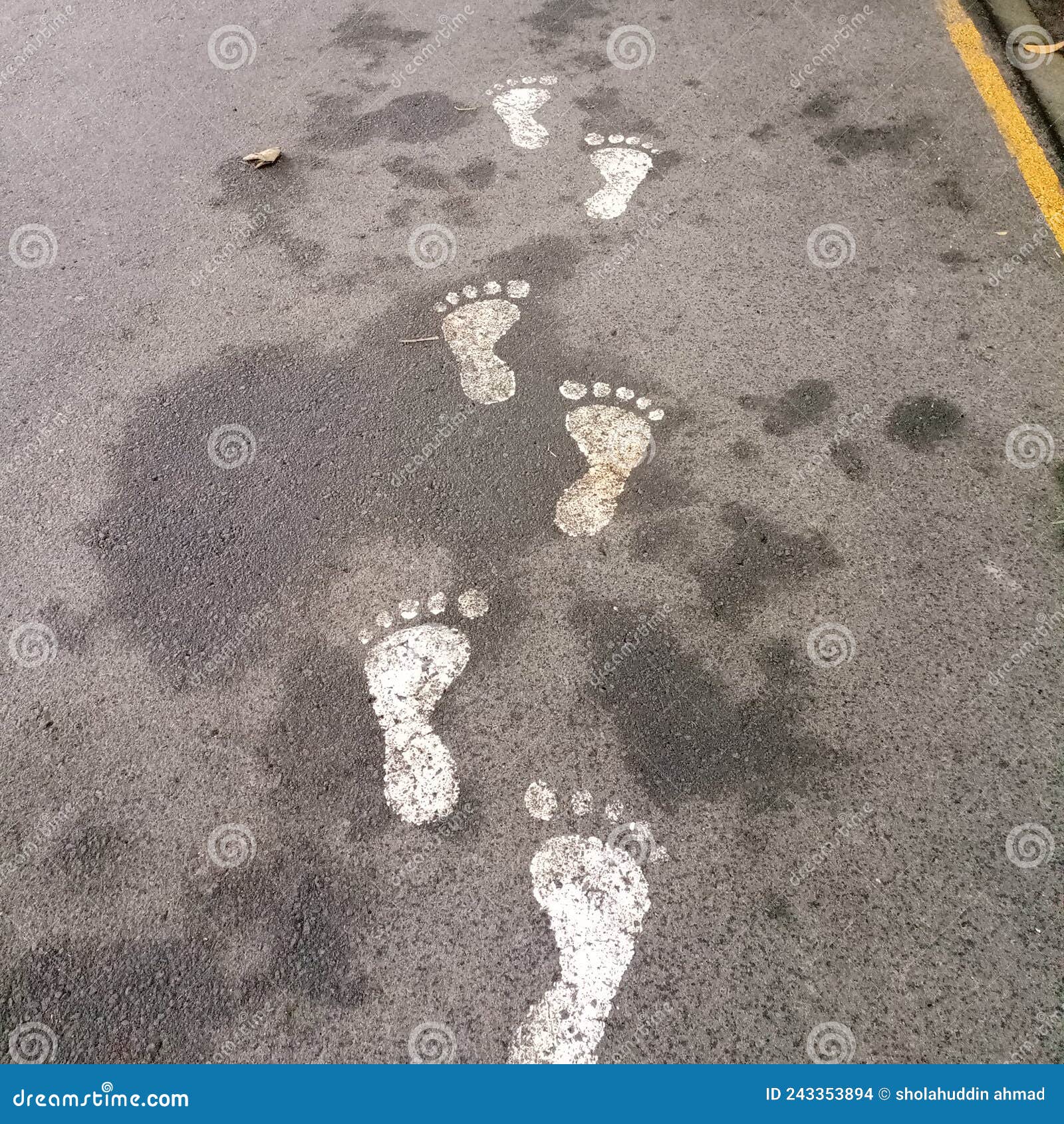 Footprints on the road stock photo. Image of sidewalk - 243353894