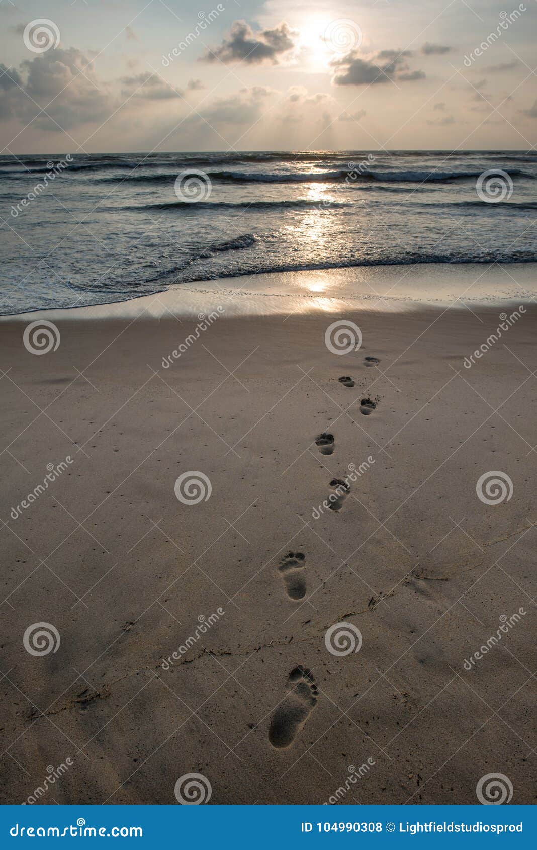Footsteps on sandy beach stock photo. Image of calming - 104990308