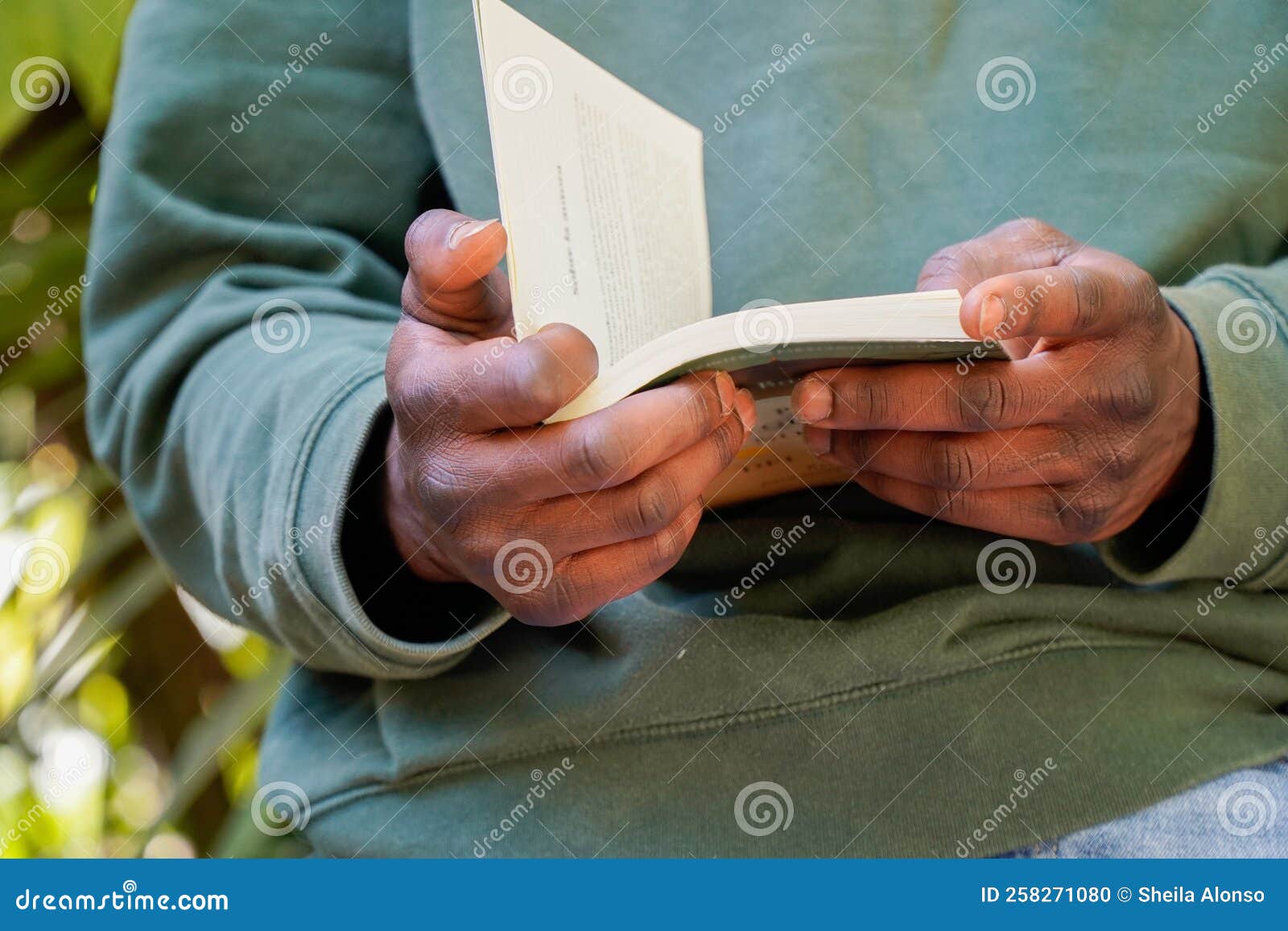 Foreground of an African Male Reading a Book Stock Photo - Image of ...