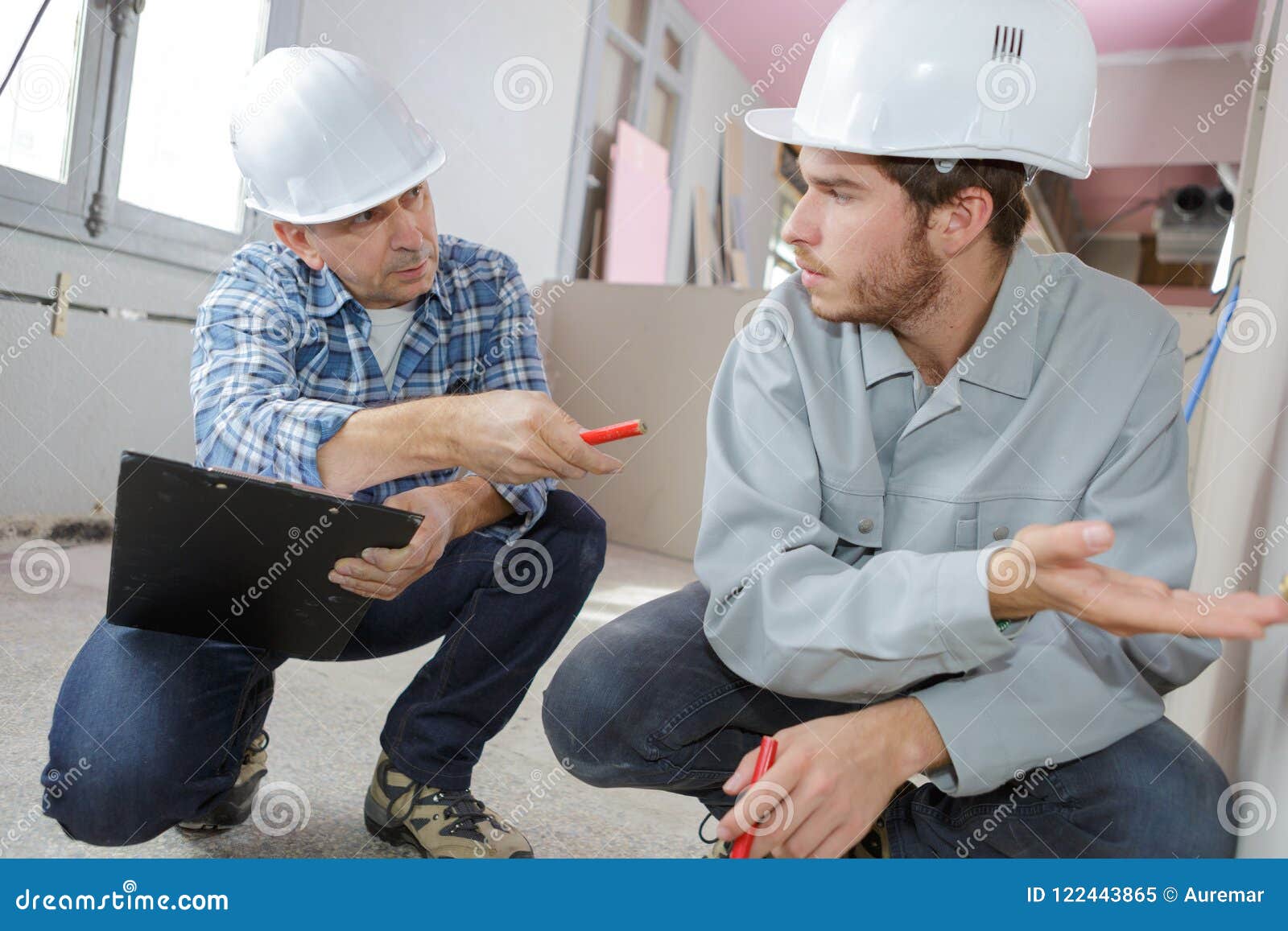 Foreman Builder and Construction Worker with Blueprint in Indoor ...