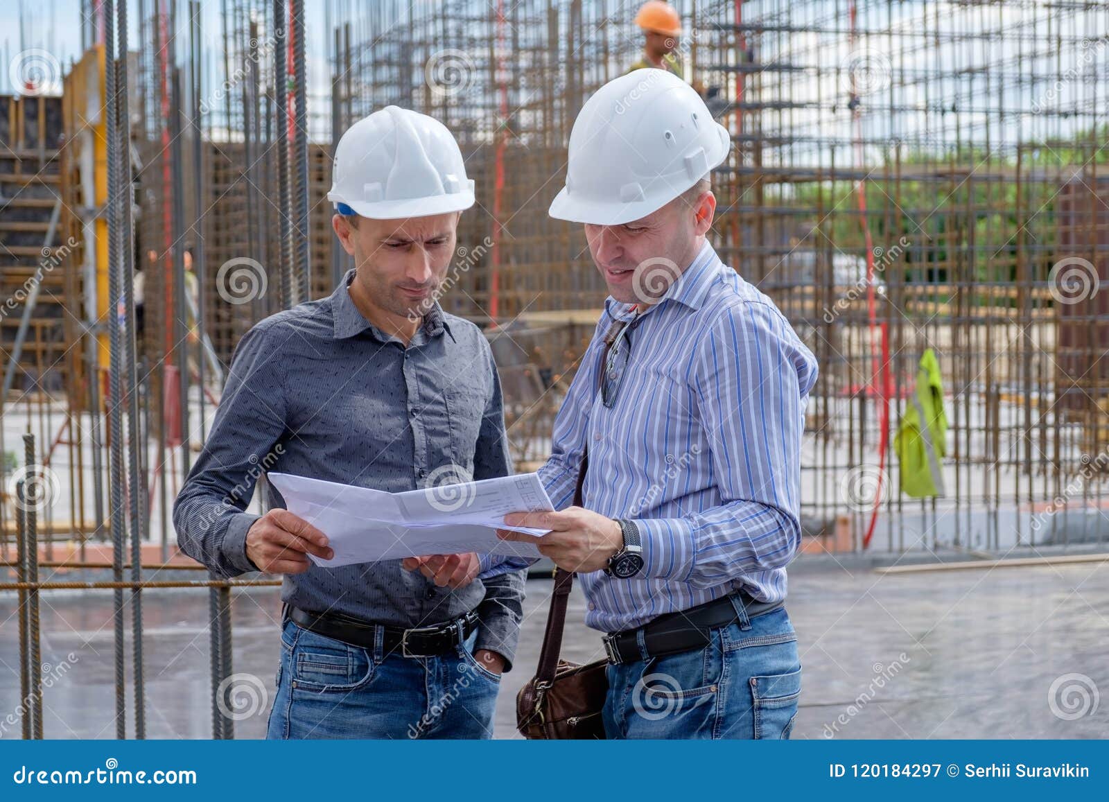 Foreman and the Contractor are Looking at the Project on the ...