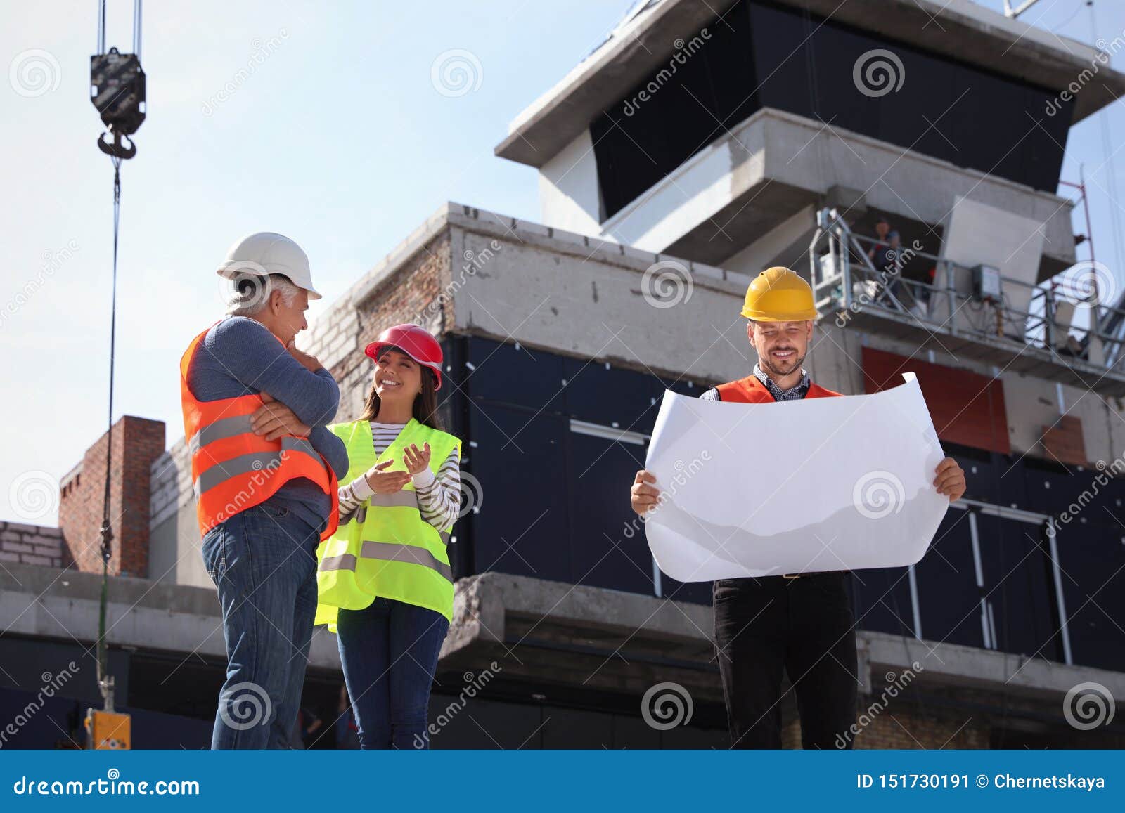 Foreman with Drafting and Engineers in Safety Equipment Stock Image ...
