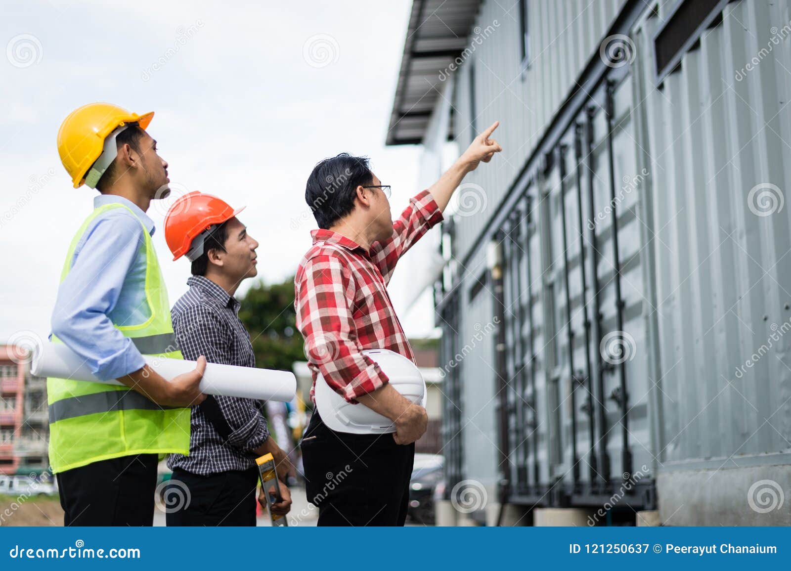 Foreman and Employee Holding Blueprint on Hand and Pointing Finger To ...