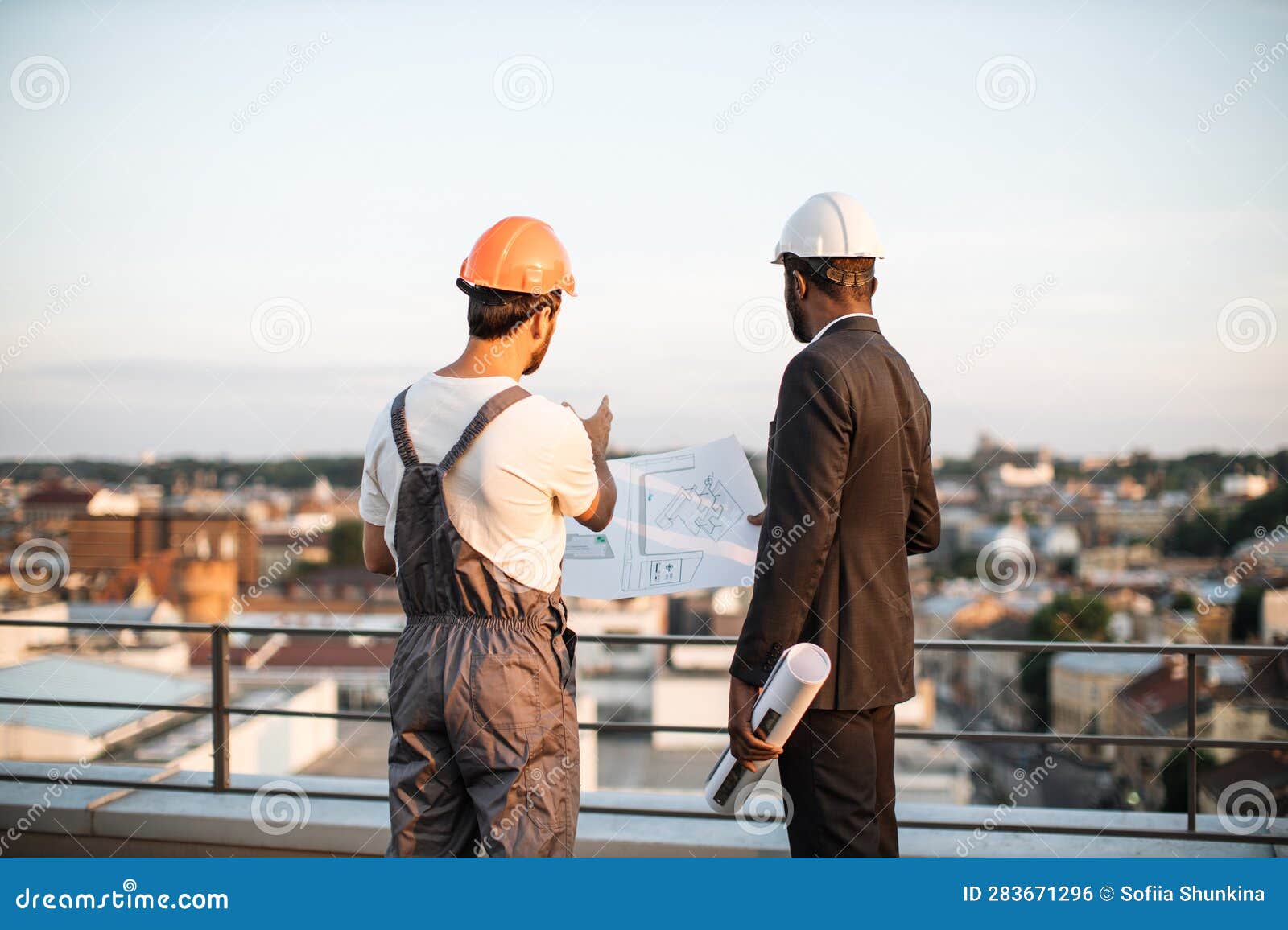 Foreman Explaining Drawings To International Engineer Stock Photo ...