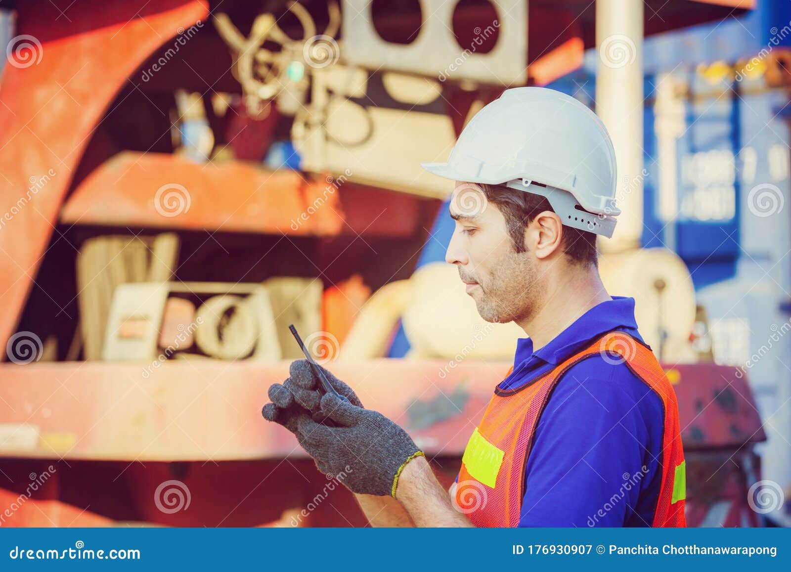 Foreman in Hardhat and Safety Vest Talks on Two-way Radio Control ...