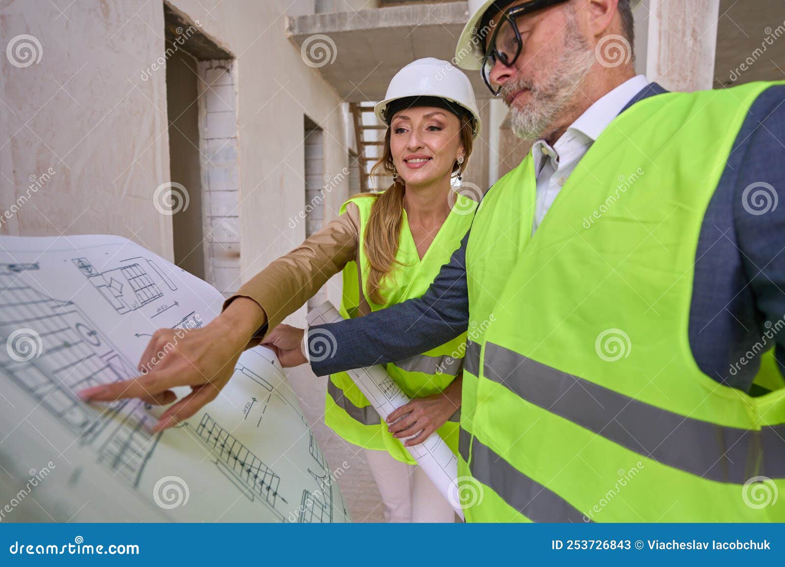 Foreman Holds Expanded Drawing, and Realtor Points To it Hand Stock ...