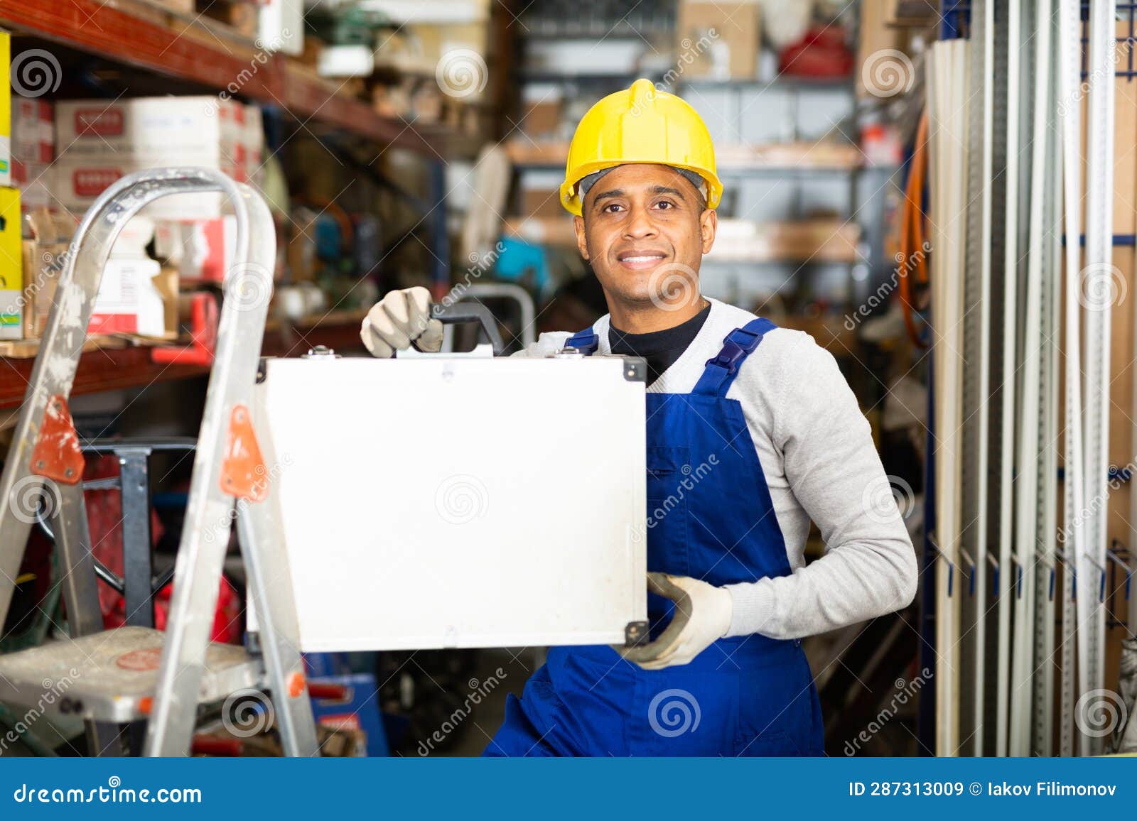 Foreman in Protective Helmet and Overalls with Toolbox in Hardware ...