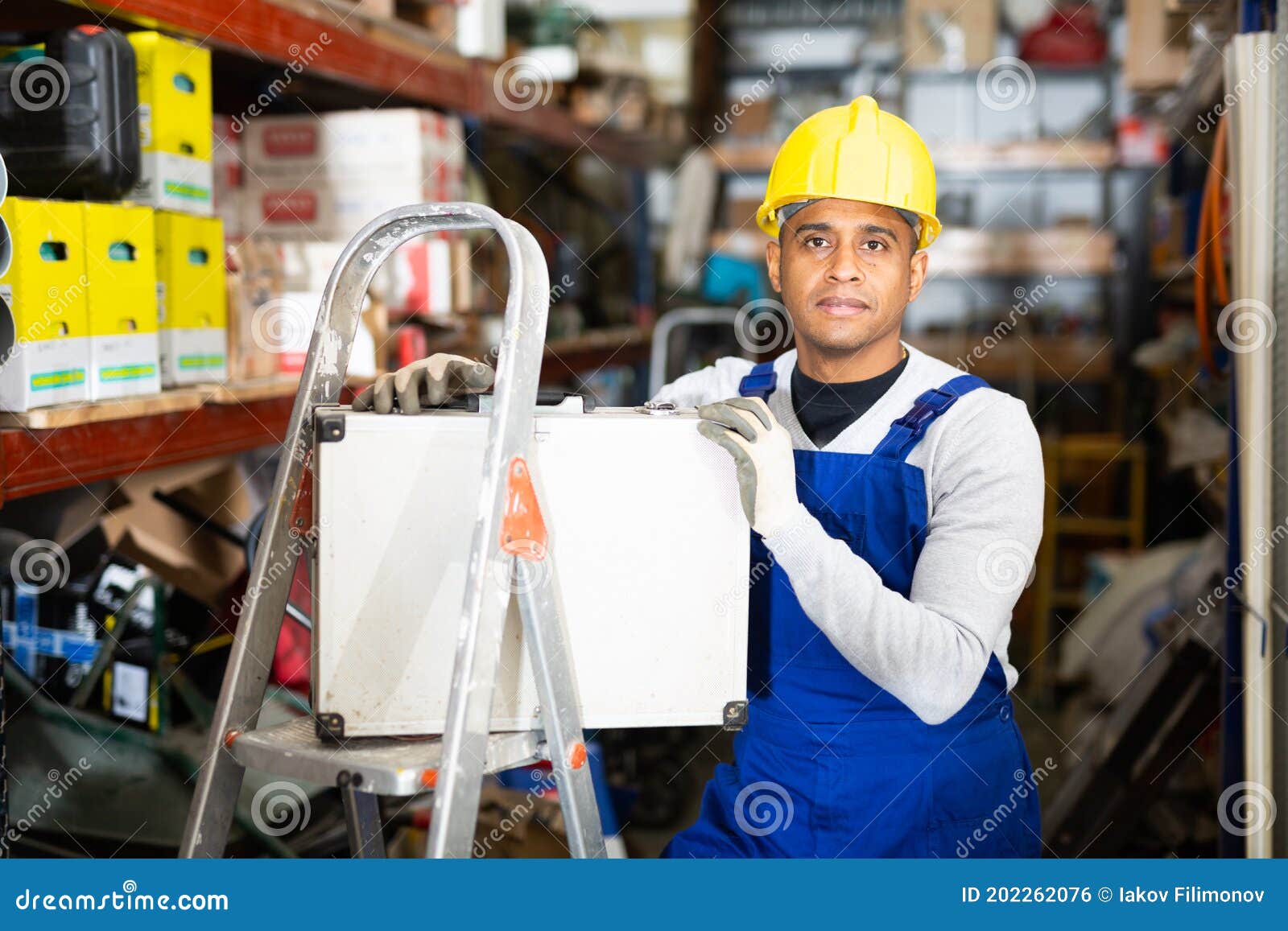 Foreman in Protective Helmet and Overalls with Toolbox in Hardware ...