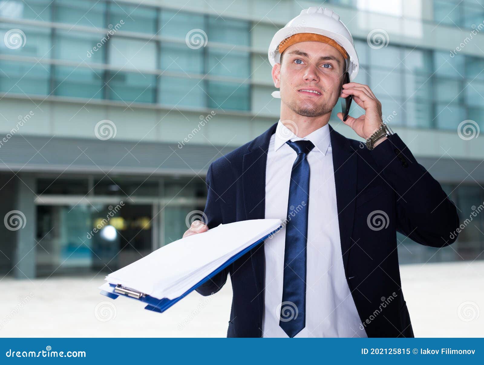 Foreman in Suit and Hat with Folder is Taking Folder and Discussing ...