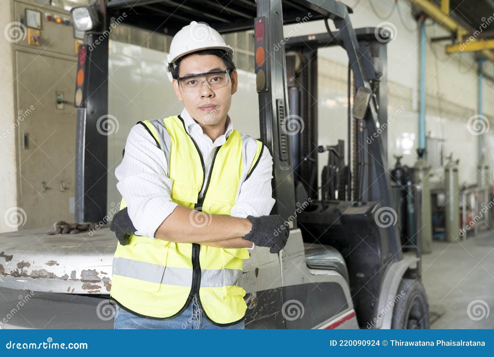 Foreman or Technician Standing with a Forklift Parked in the Factory ...