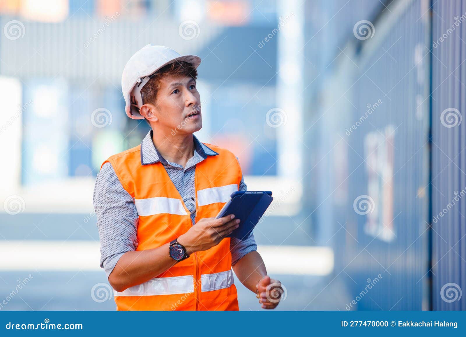 Foreman in Uniform Wearing Safety Helmet Using Tablet Checking ...