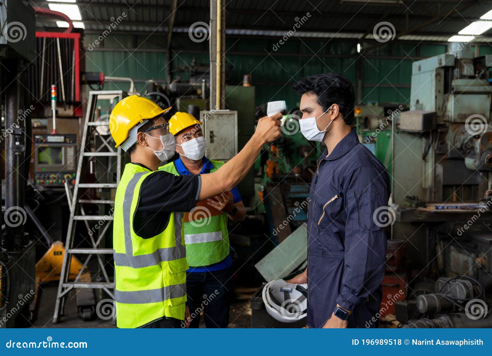 Foreman Using an Infrared Thermometer Measuring Temperature To Check ...