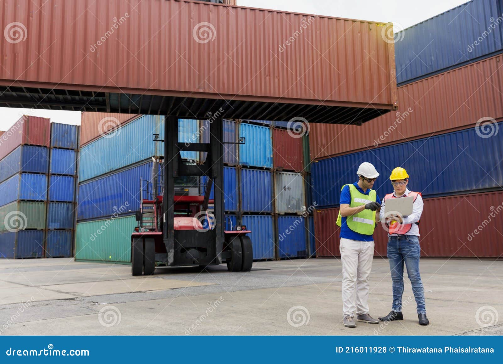 Foreman Using Laptop Computer in the Port of Loading Goods. Foreman ...