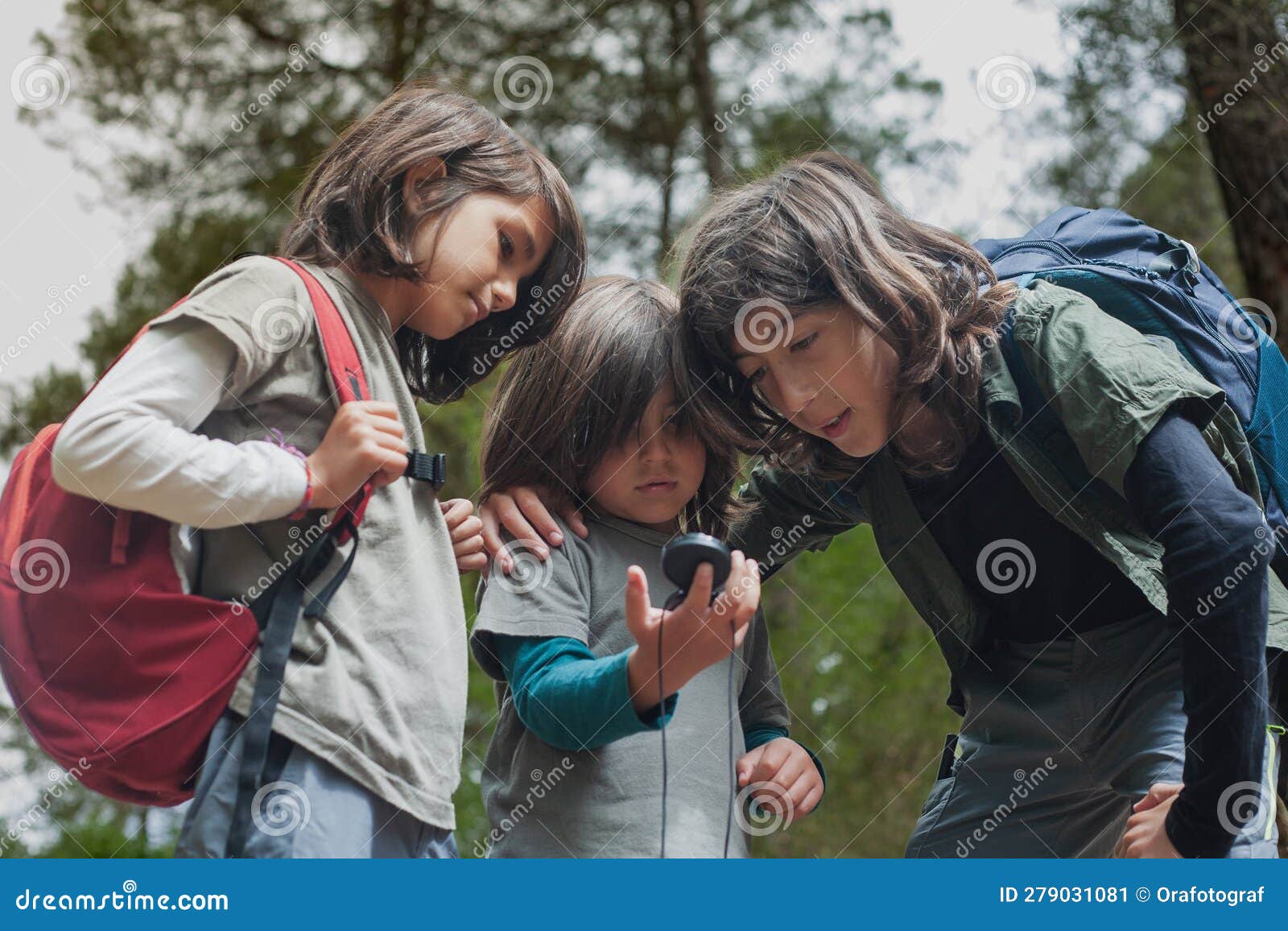 Forest Exploration: Three Children Using a Compass To Navigate and Find ...
