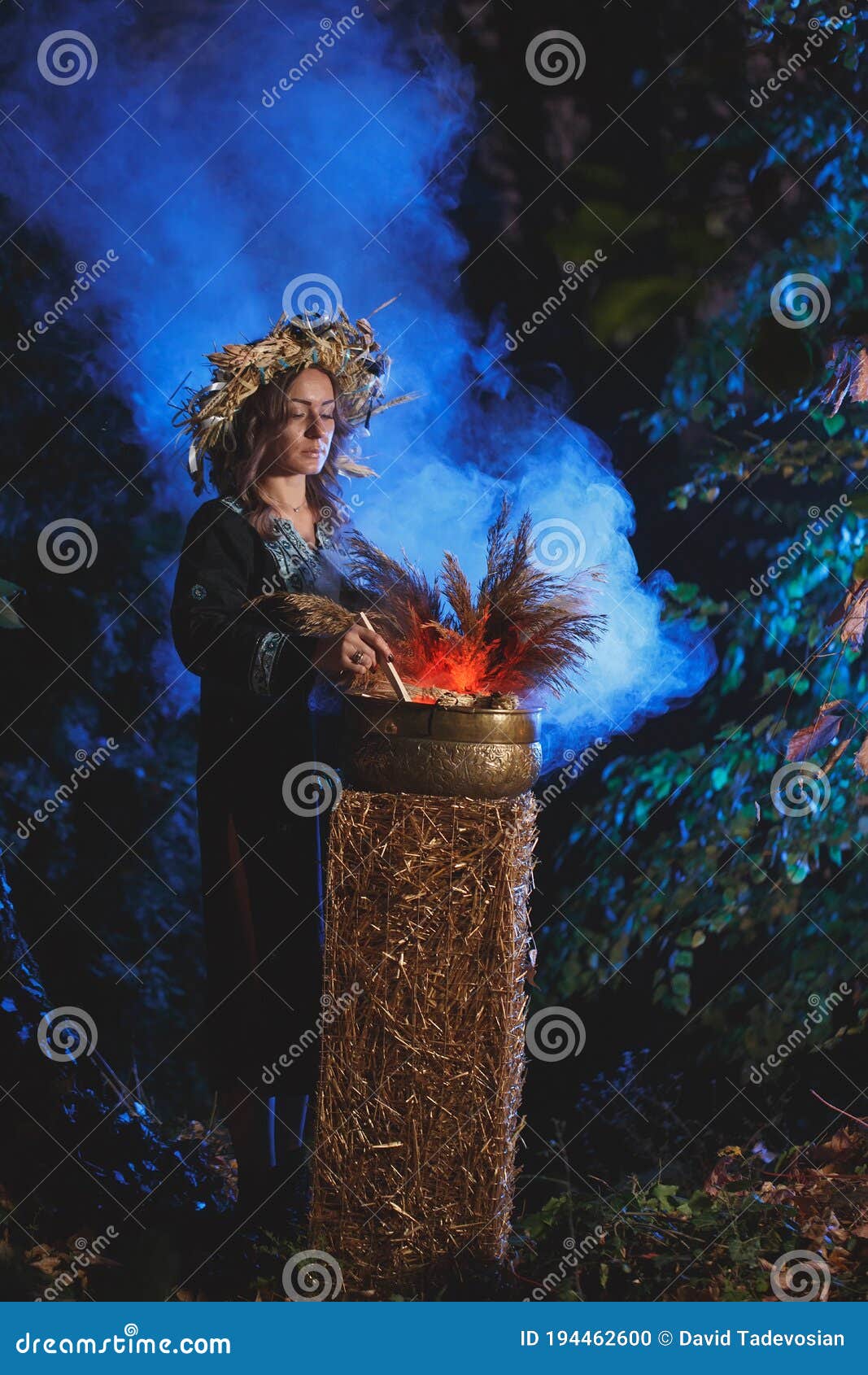 A Forest Witch Brews a Potion Holding a Voodoo Doll. Stock Photo ...