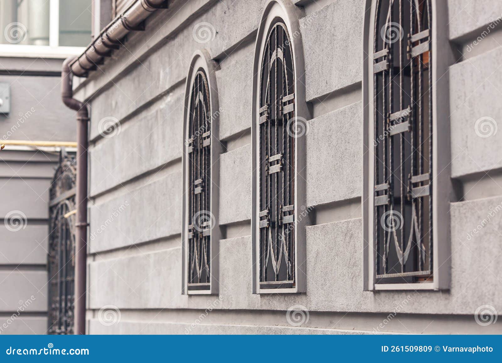 Forged Bars on the Arched Windows of the Building. Stock Image - Image ...