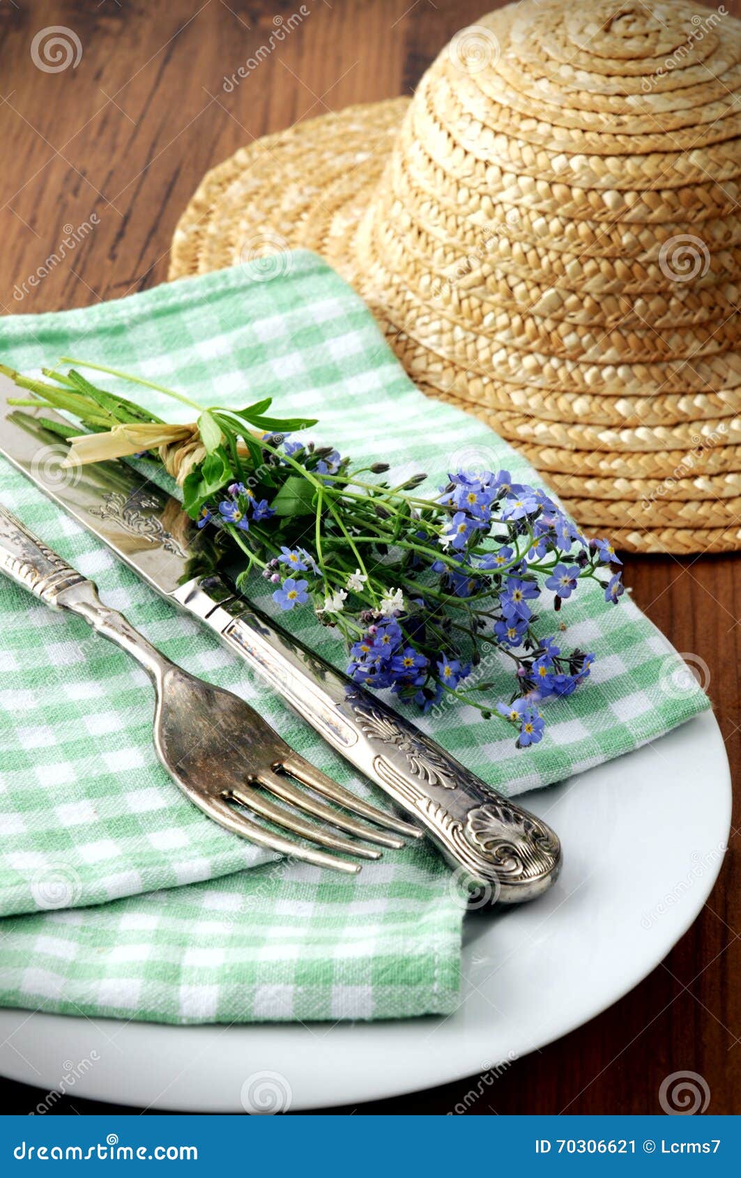 Forget-me-not Flowers on Plate with Silverware and Straw Hat Aside ...