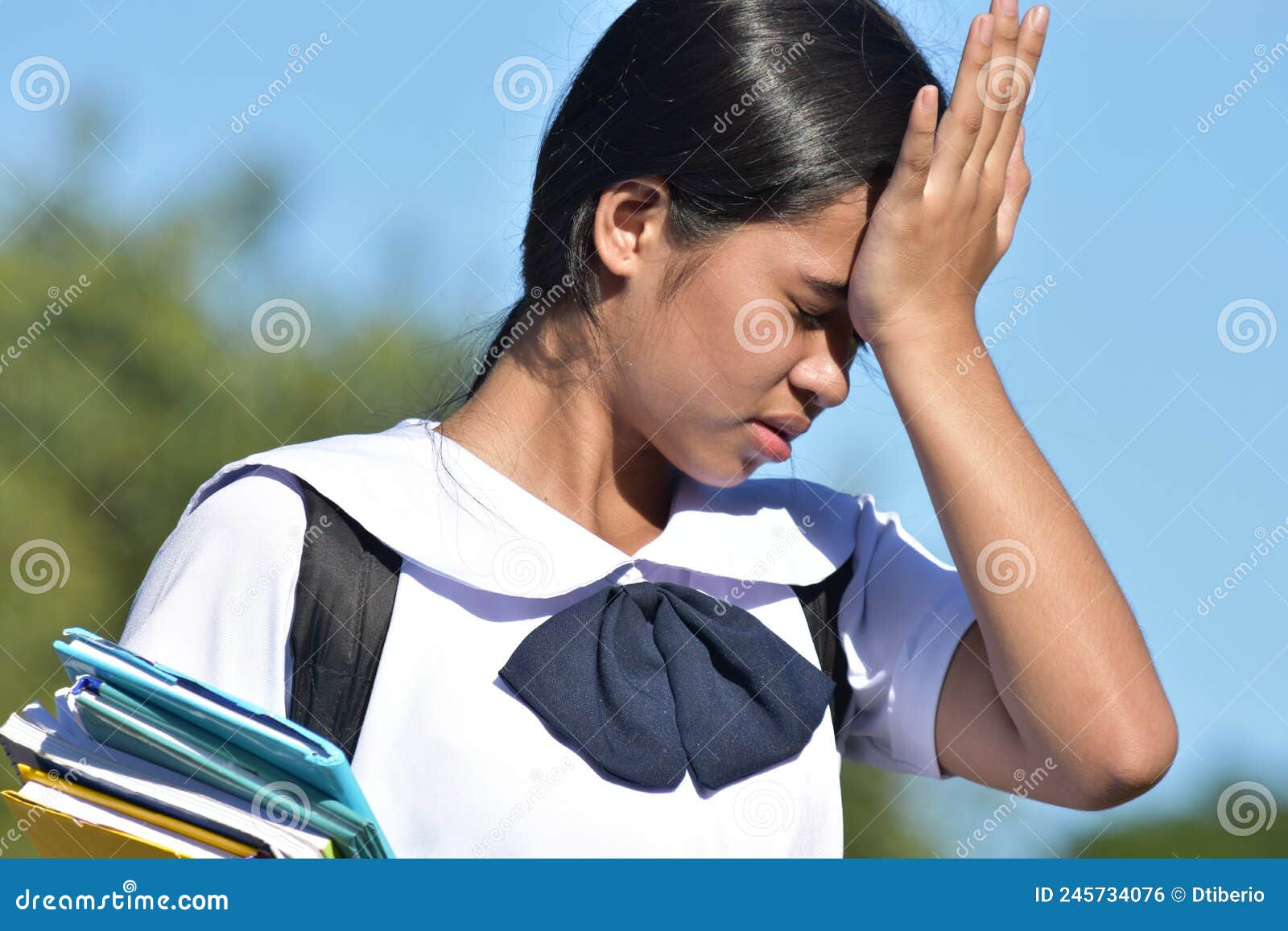 A Forgetful Female Student Holding Books Stock Photo - Image of pupil ...