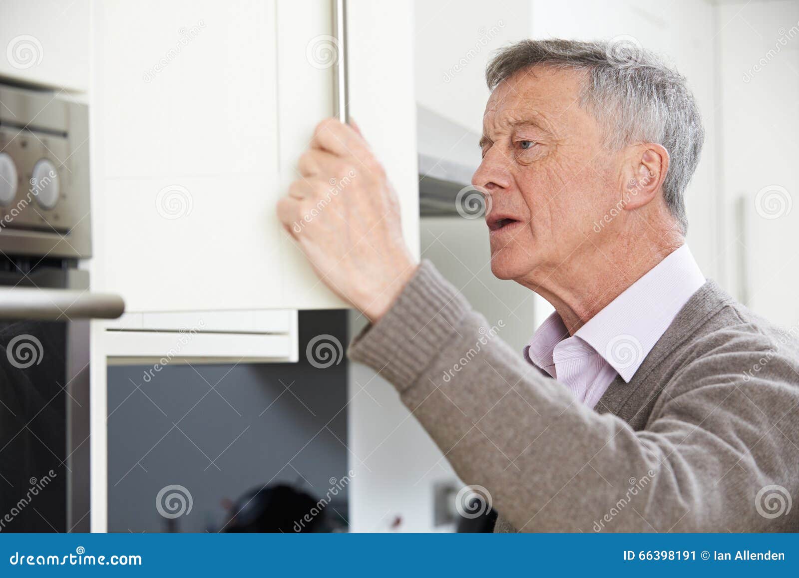 Forgetful Senior Man Looking in Cupboard Stock Image - Image of indoors ...