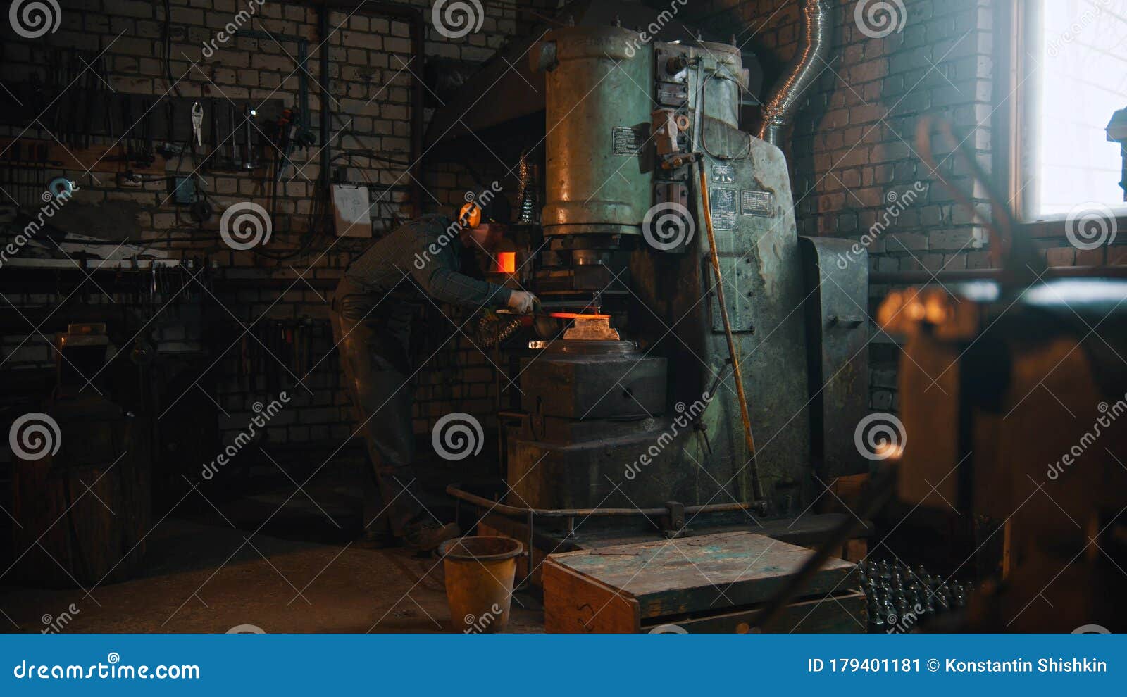 Forging Industry - a Man Blacksmith Working with Big Pressure Machine ...