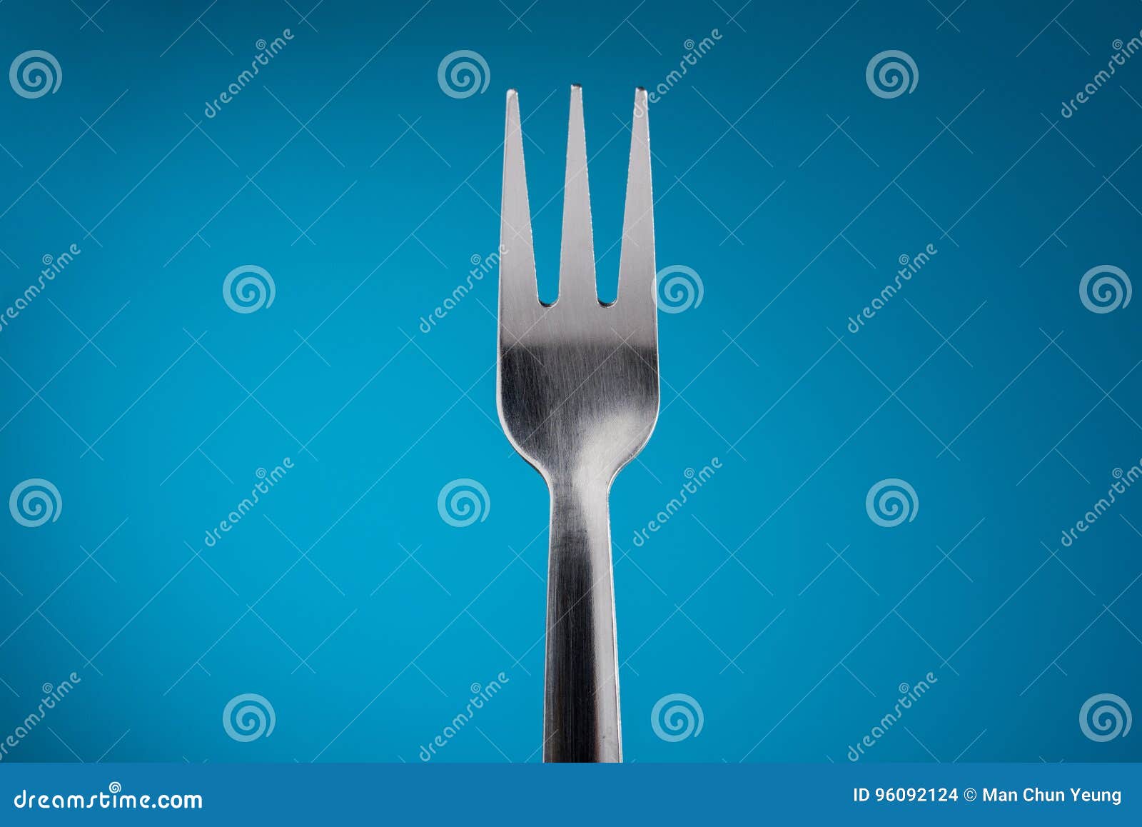 Fork in Blue Background in Studio Stock Photo - Image of blank, angle ...