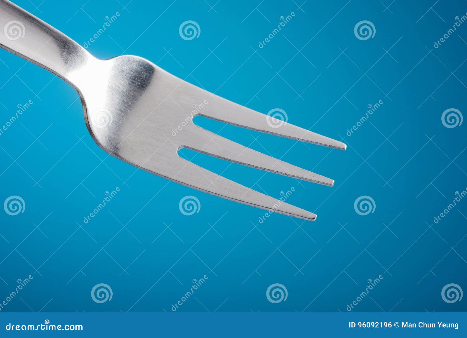 Fork in Blue Background in Studio Stock Photo - Image of colored ...
