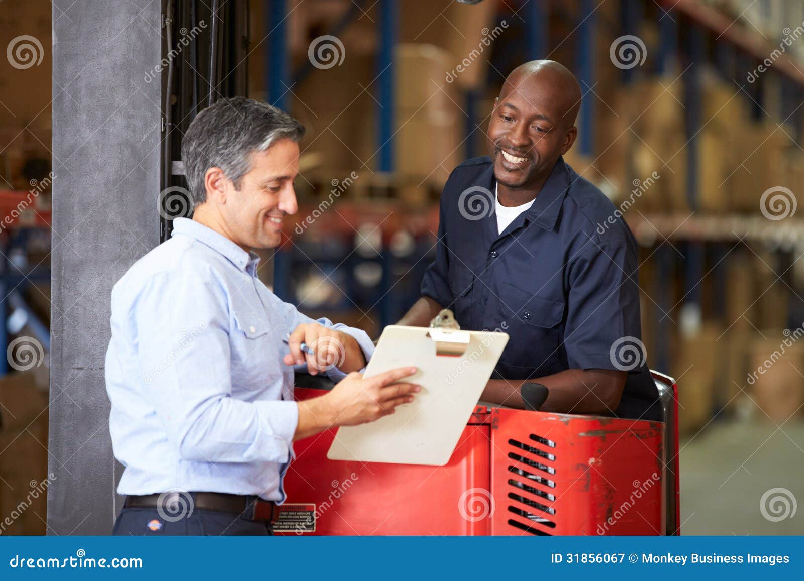 Fork Lift Truck Operator Talking To Manager in Warehouse Stock Image ...