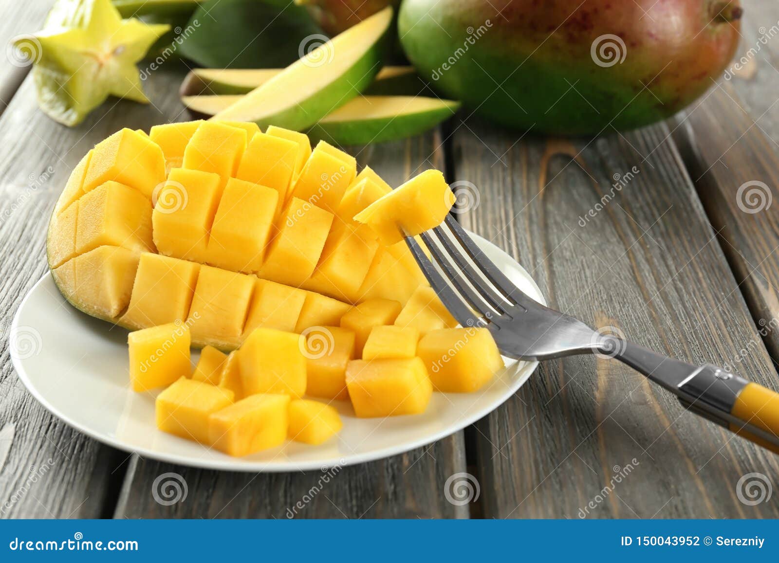 Fork and Plate with Fresh Cut Mango on Table, Closeup Stock Photo ...