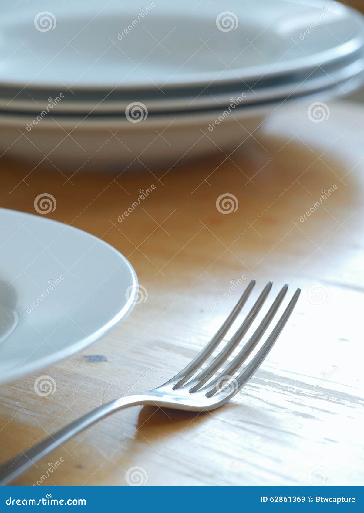 Fork and Plates Lying on Wooden Table Stock Image - Image of cutlery ...