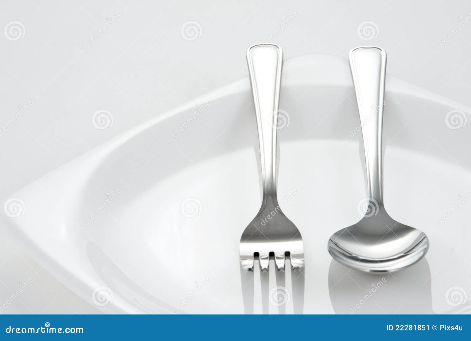 Fork & Spoon on White Dish Stock Image - Image of cafe, cook: 22281851