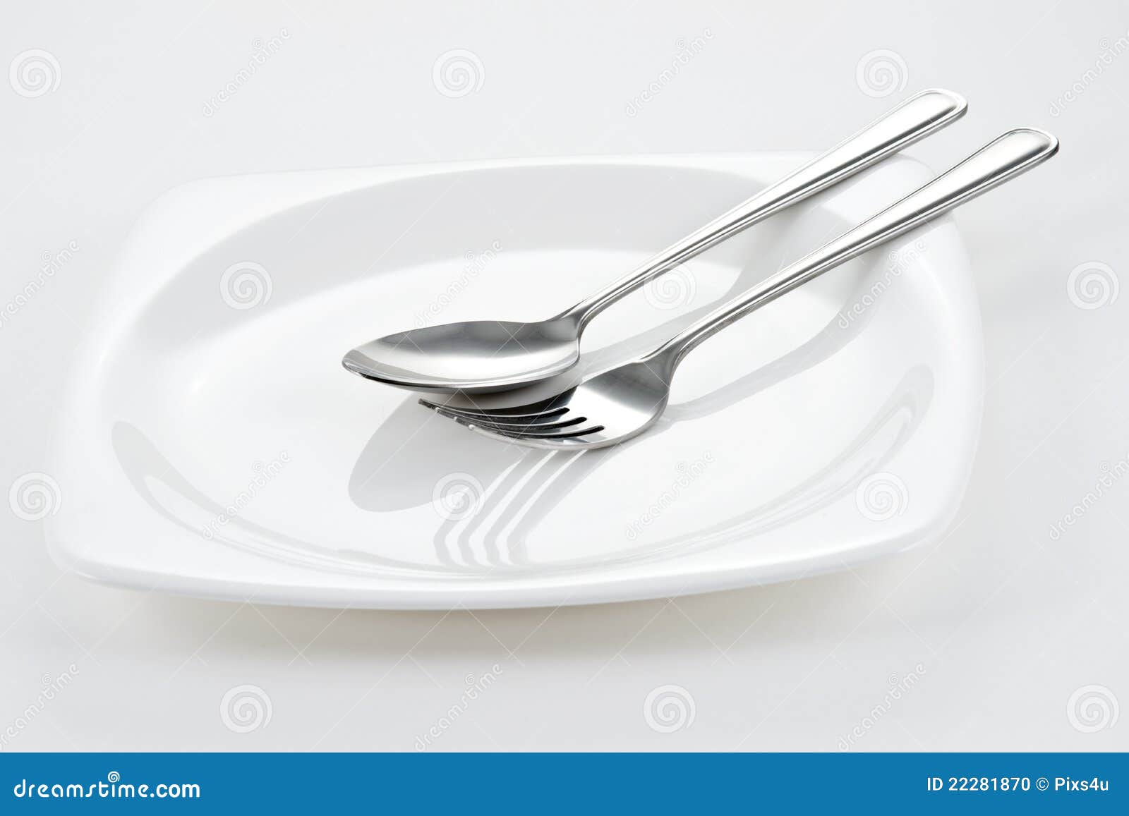 Fork & Spoon on White Dish Stock Photo - Image of plate, lunch: 22281870