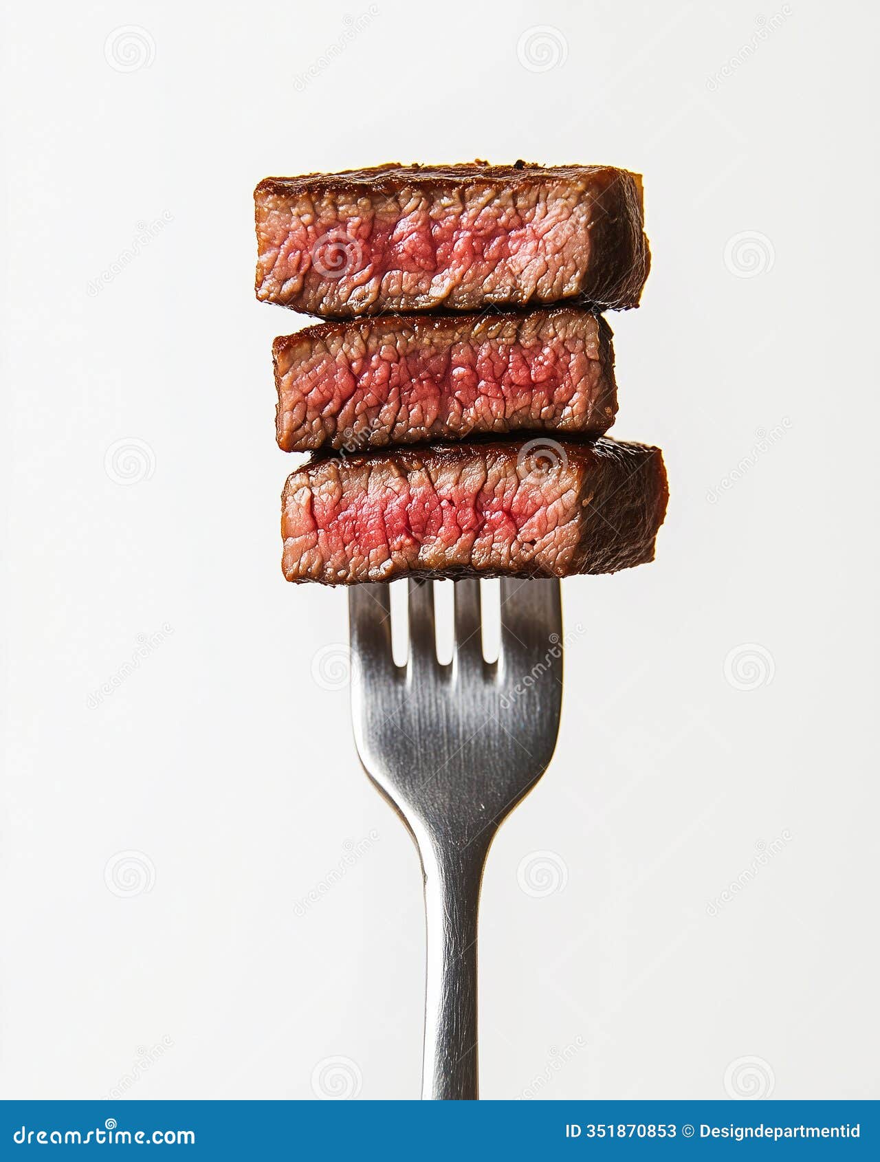 A Fork with Three Pieces of Steak Stacked on Top Stock Image - Image of ...